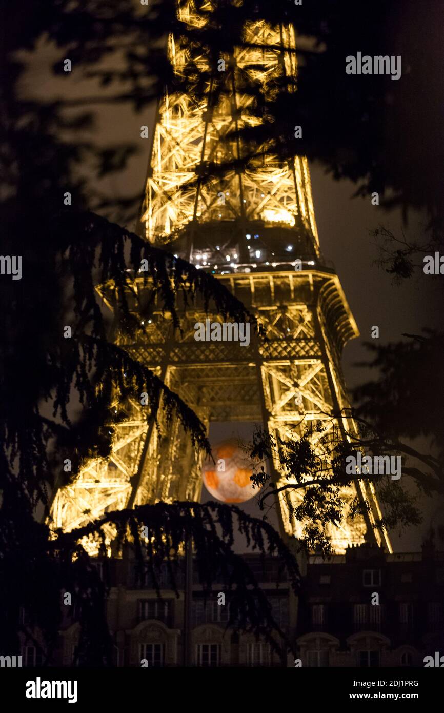 An inflated ball hung inside the Eiffel Tower next to the under ...