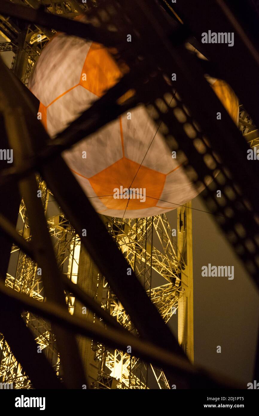 An inflated ball hung inside the Eiffel Tower next to the under ...