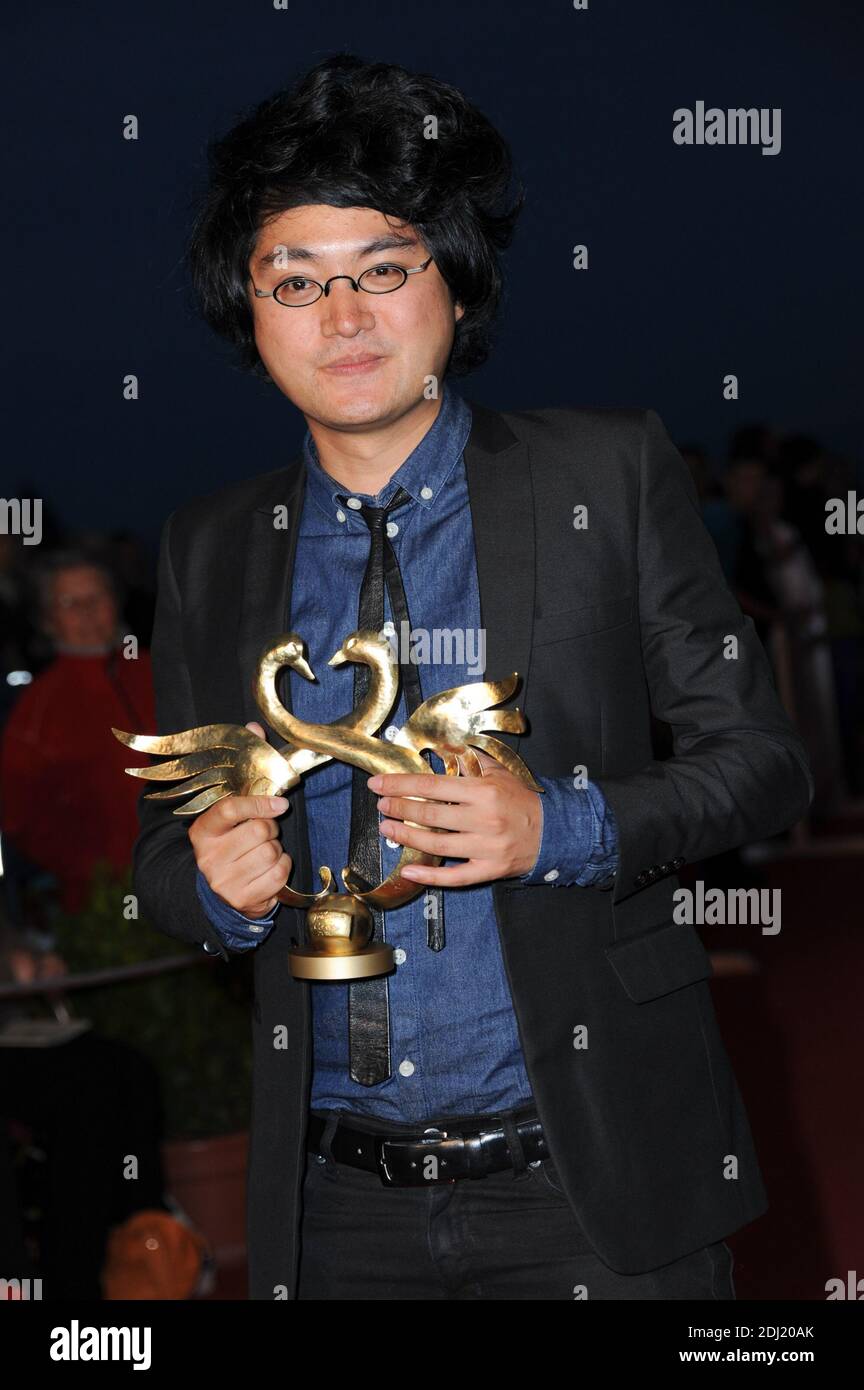 Davy Chou posing with his Swann (Grand prix) for the movie 'Diamond island' during the 30th ...
