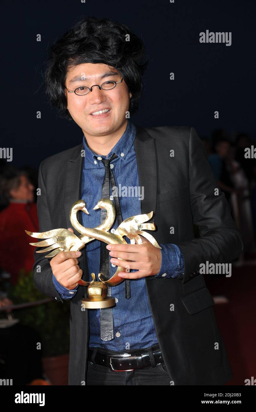 Davy Chou posing with his Swann (Grand prix) for the movie 'Diamond island' during the 30th ...