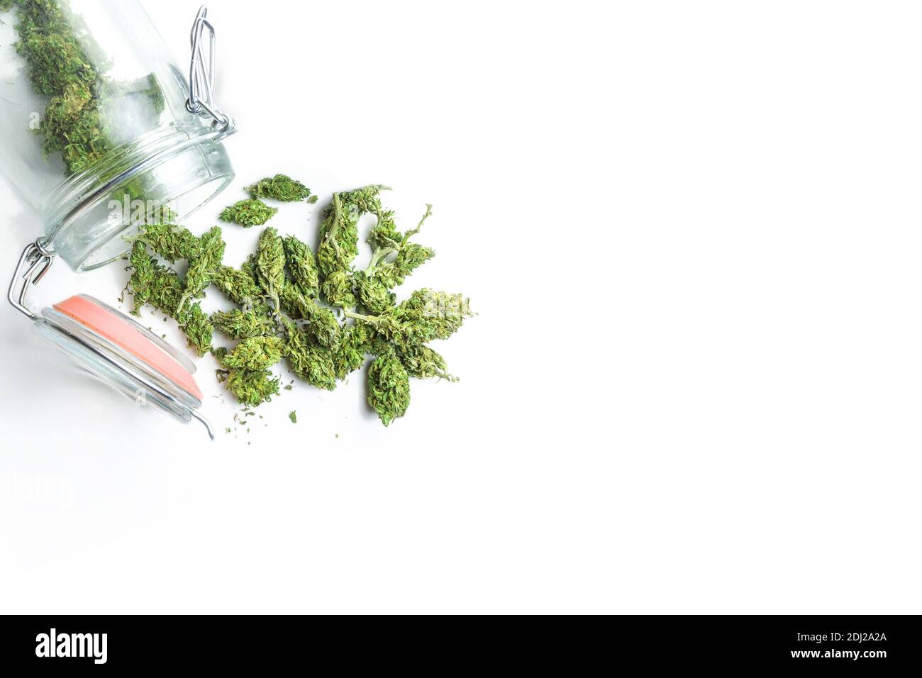Jar with Medical Marijuana flower buds spill on white background with ...