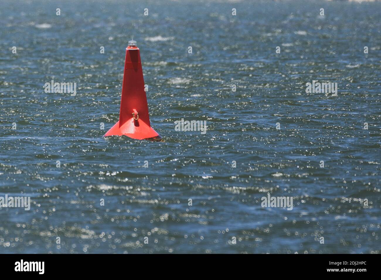 A red navigation beacon floating on the water Stock Photo - Alamy