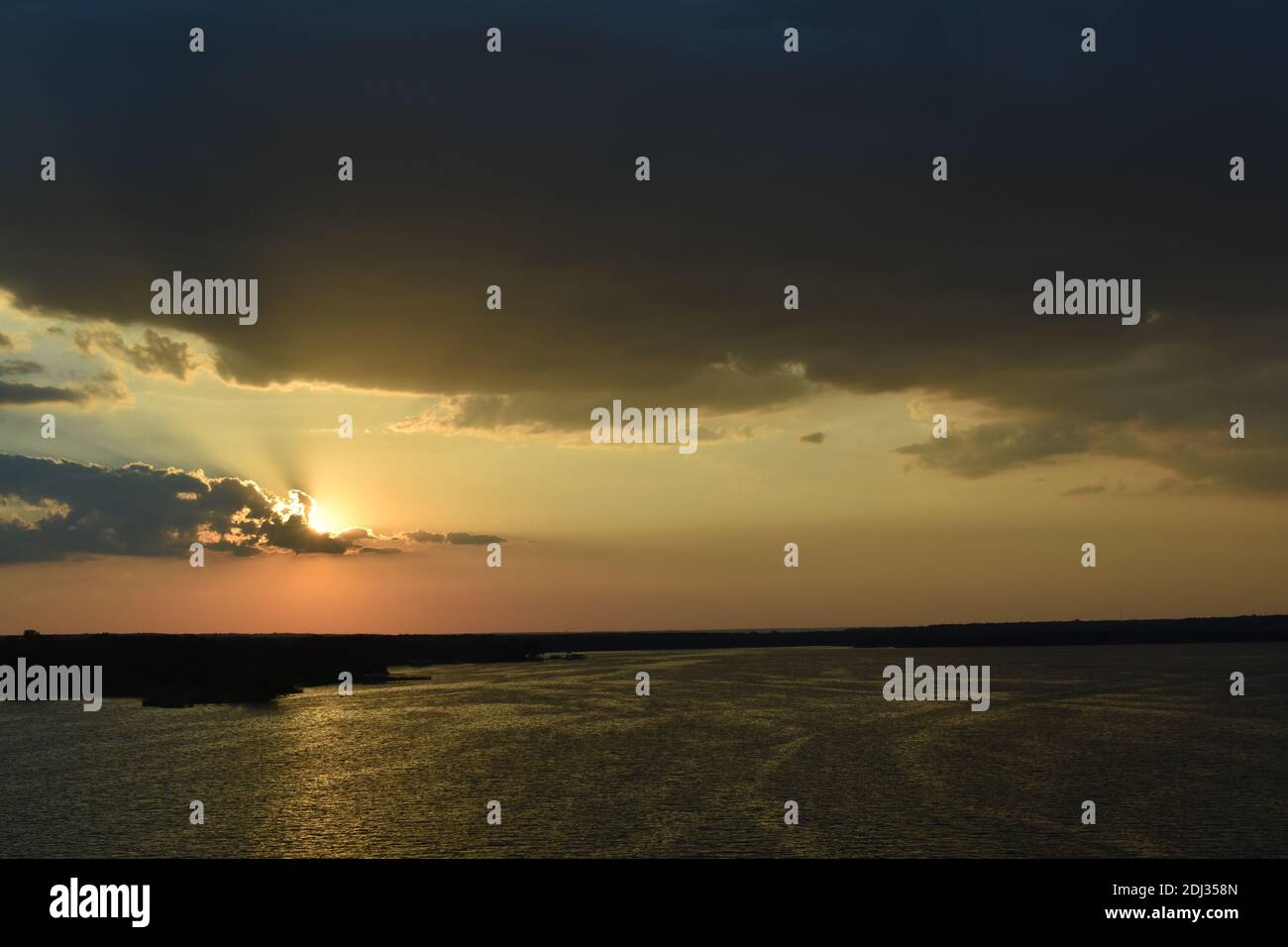 sun over lake Stock Photo - Alamy