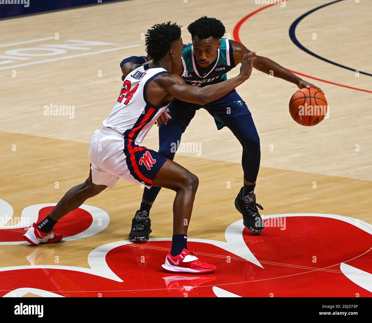 Oxford, MS, USA. 12th Dec, 2020. UNCW guard, Mike Okauru (4), drives ...