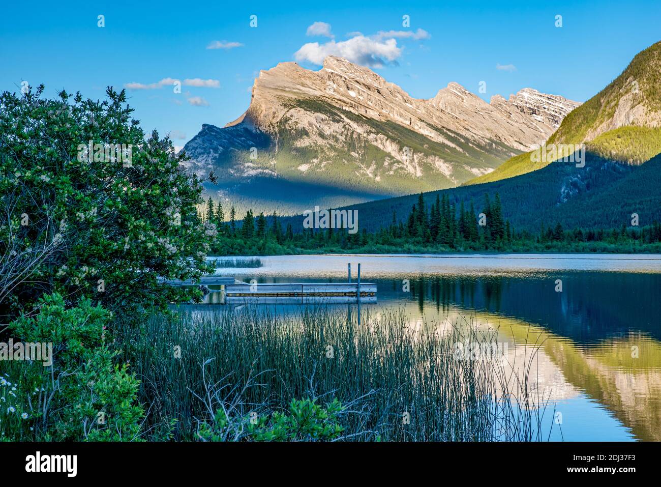 View of Mount Rundle reflected in the water of Vermillion Lakes in ...