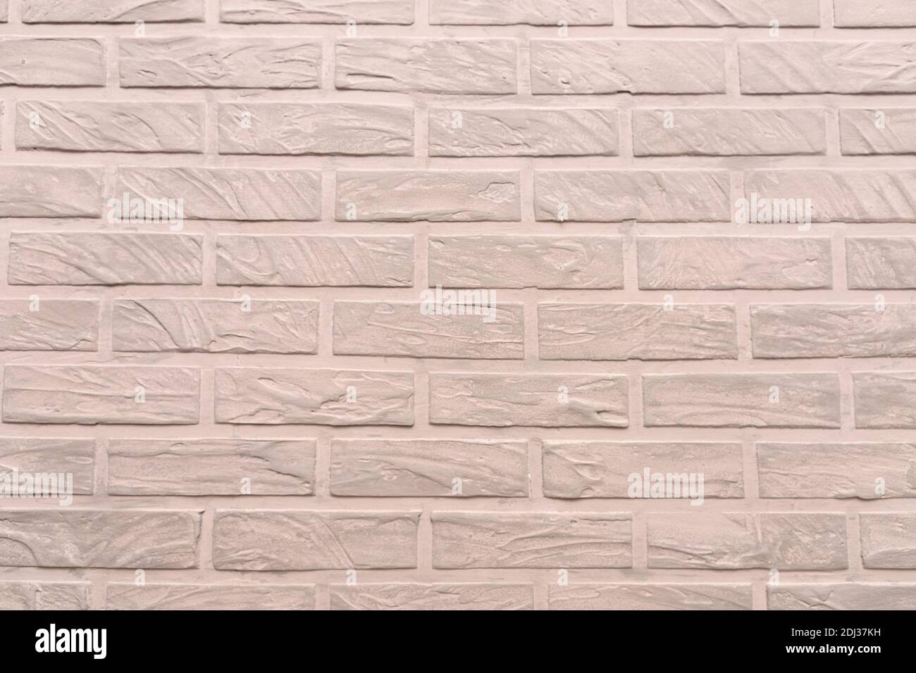 Background of the wall, decorated with decorative plaster beige bricks ...