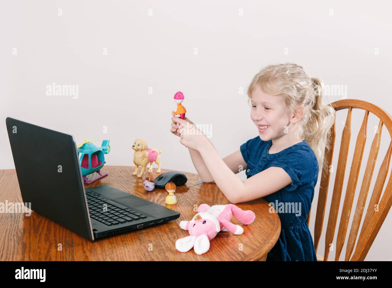 Cute adorable smiling Caucasian girl playing toys with friends on video ...