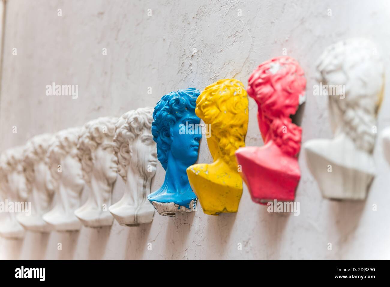 Statues of david with colors on the wall in Dafen Oil Painting village ...