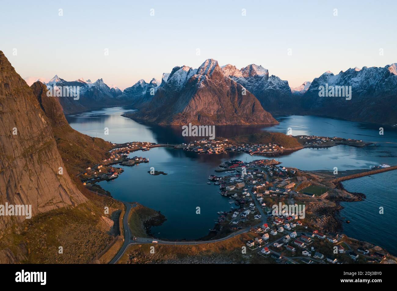 Aerial view, Reine with bringing in fjord at sunrise, colourful huts ...