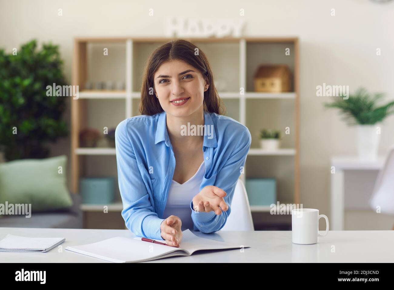 Smiling woman explaining project for colleague Stock Photo - Alamy