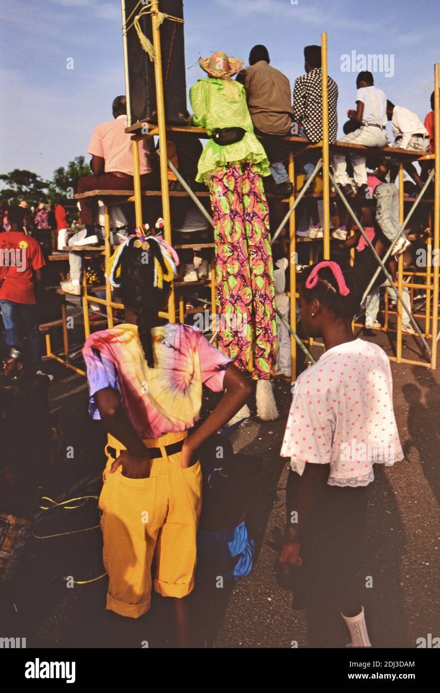 1990s Trinidad and Tobago - The Moko Jumbie (on stilts) watches ...