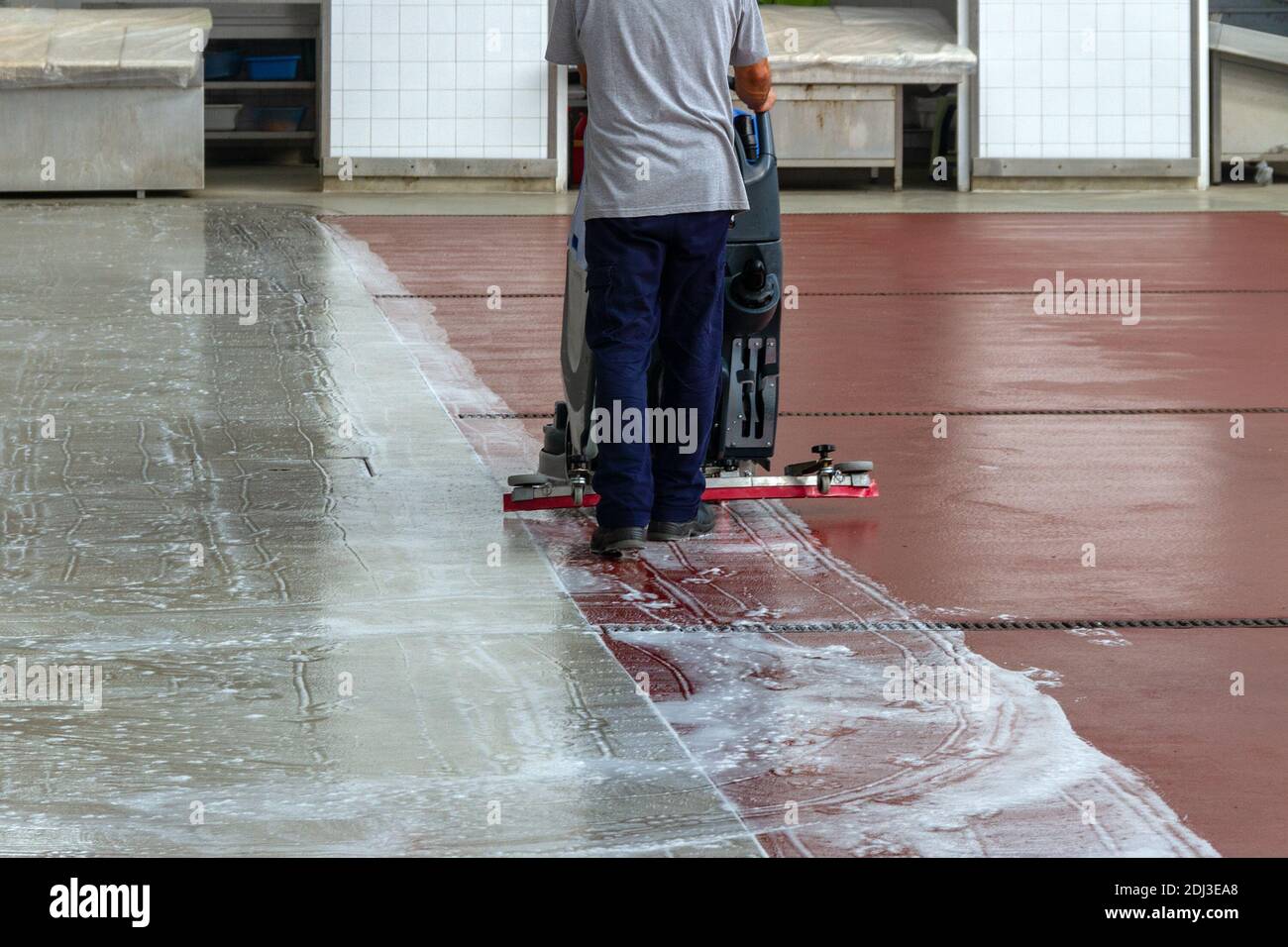 Worker cleans floor by machine Stock Photo - Alamy