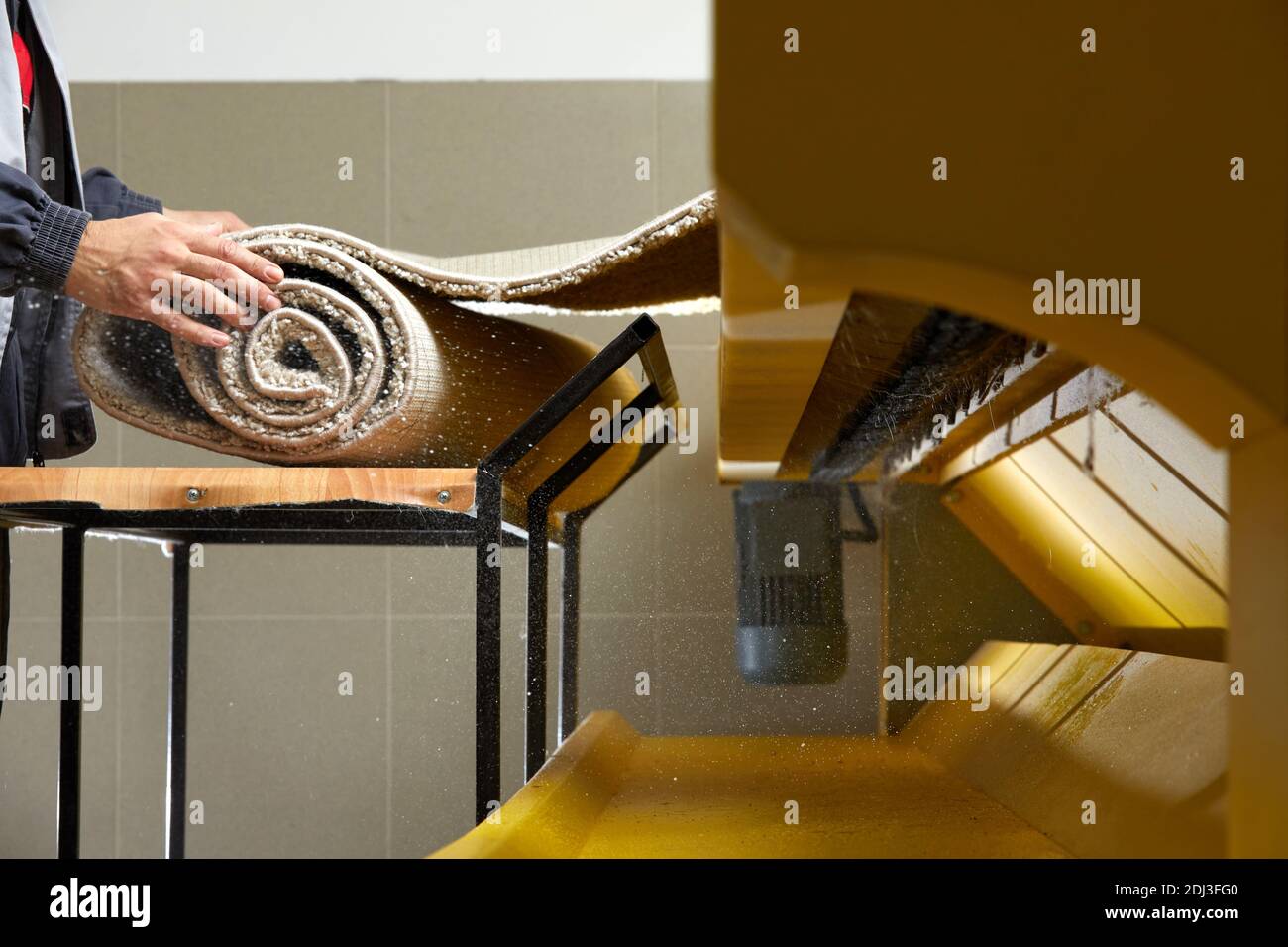 Male worker cleaning carpet on automatic washing machine equipment and ...