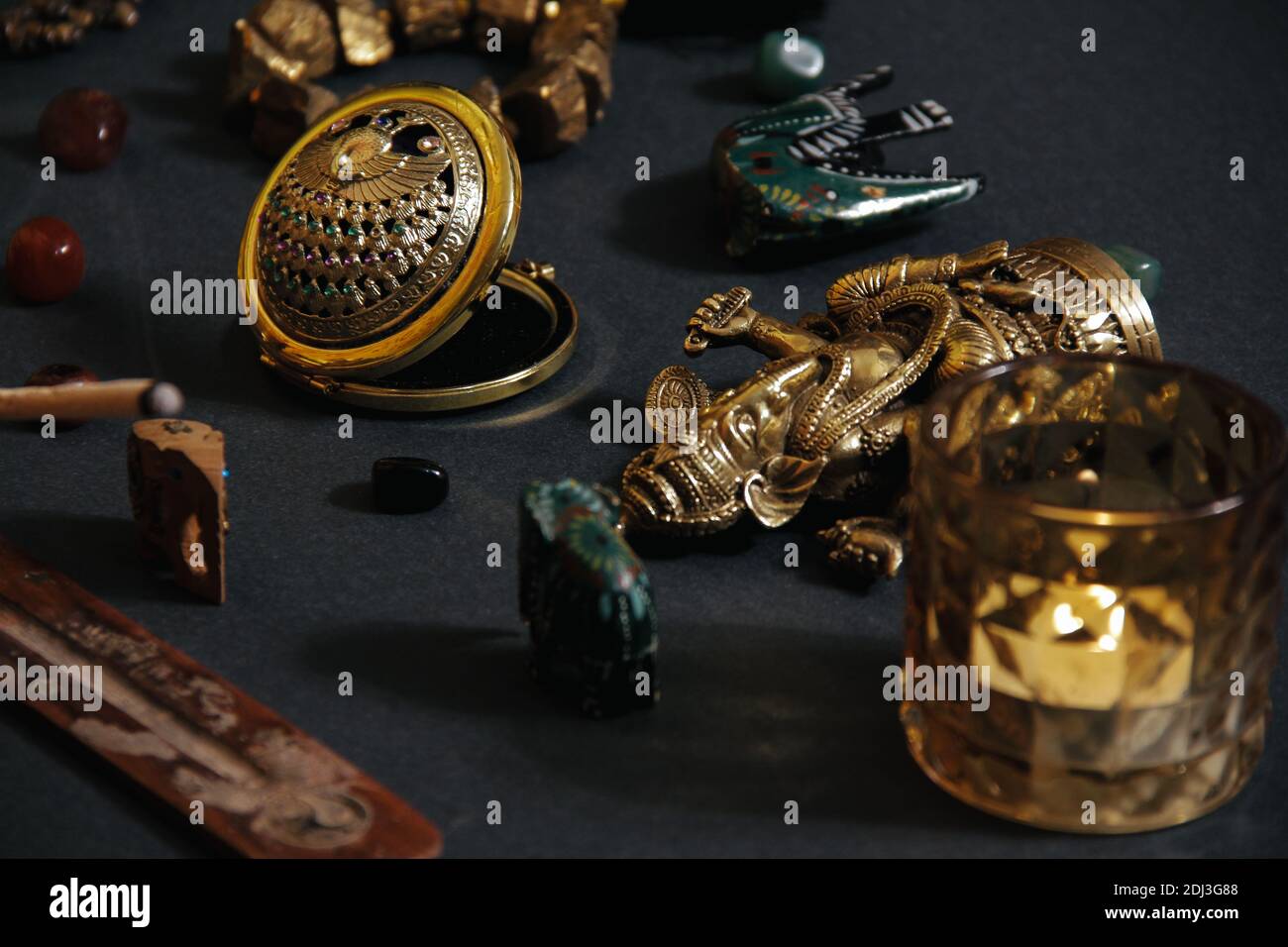 Table with occult attributes, top view. Ganesha figurine, stone ...