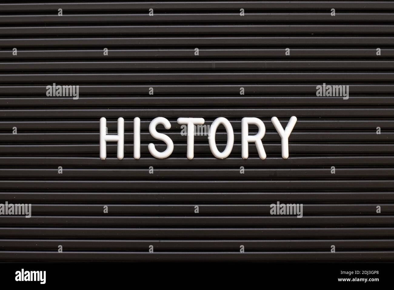 White alphabet in word history on black color felt letter board ...