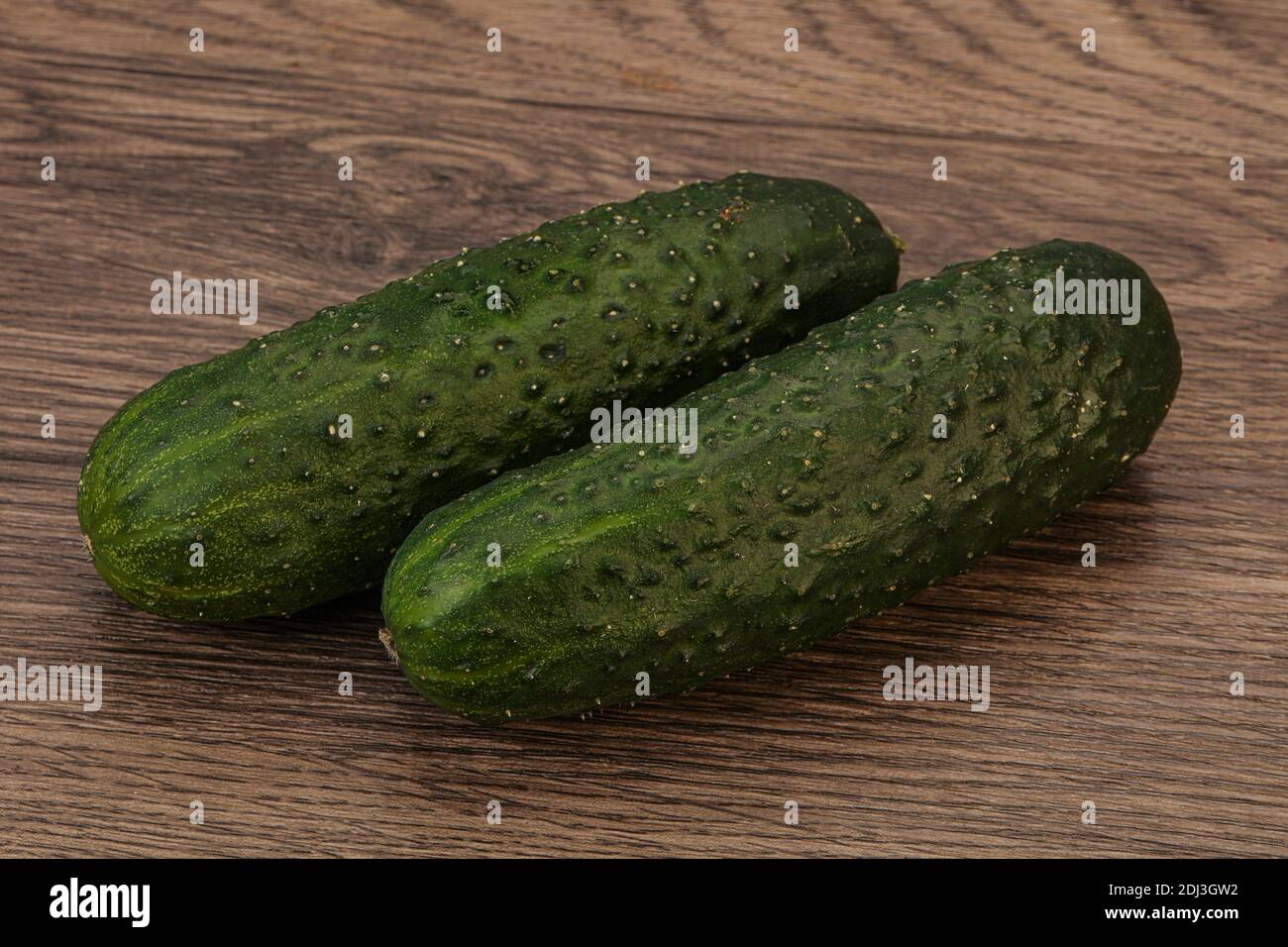 Green fresh two cucumbers over background Stock Photo - Alamy