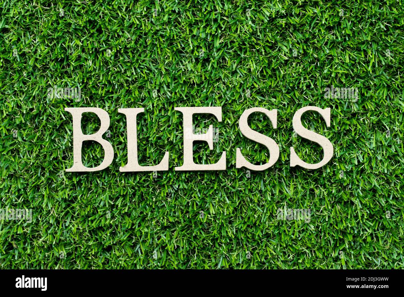 Wood alphabet letter in word bless on green grass background Stock ...