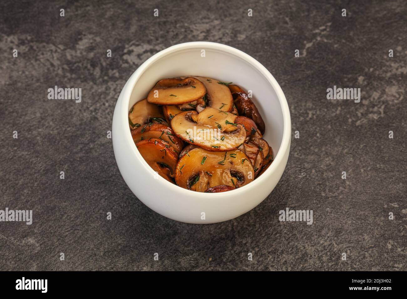 Roasted champignon with herbs and spices in the bowl Stock Photo - Alamy