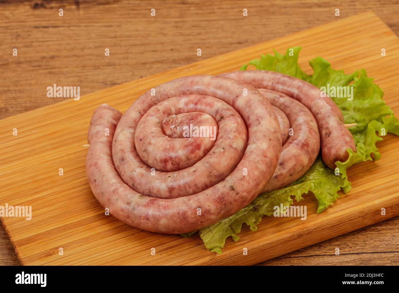 Raw pork sausage ring for grill Stock Photo - Alamy