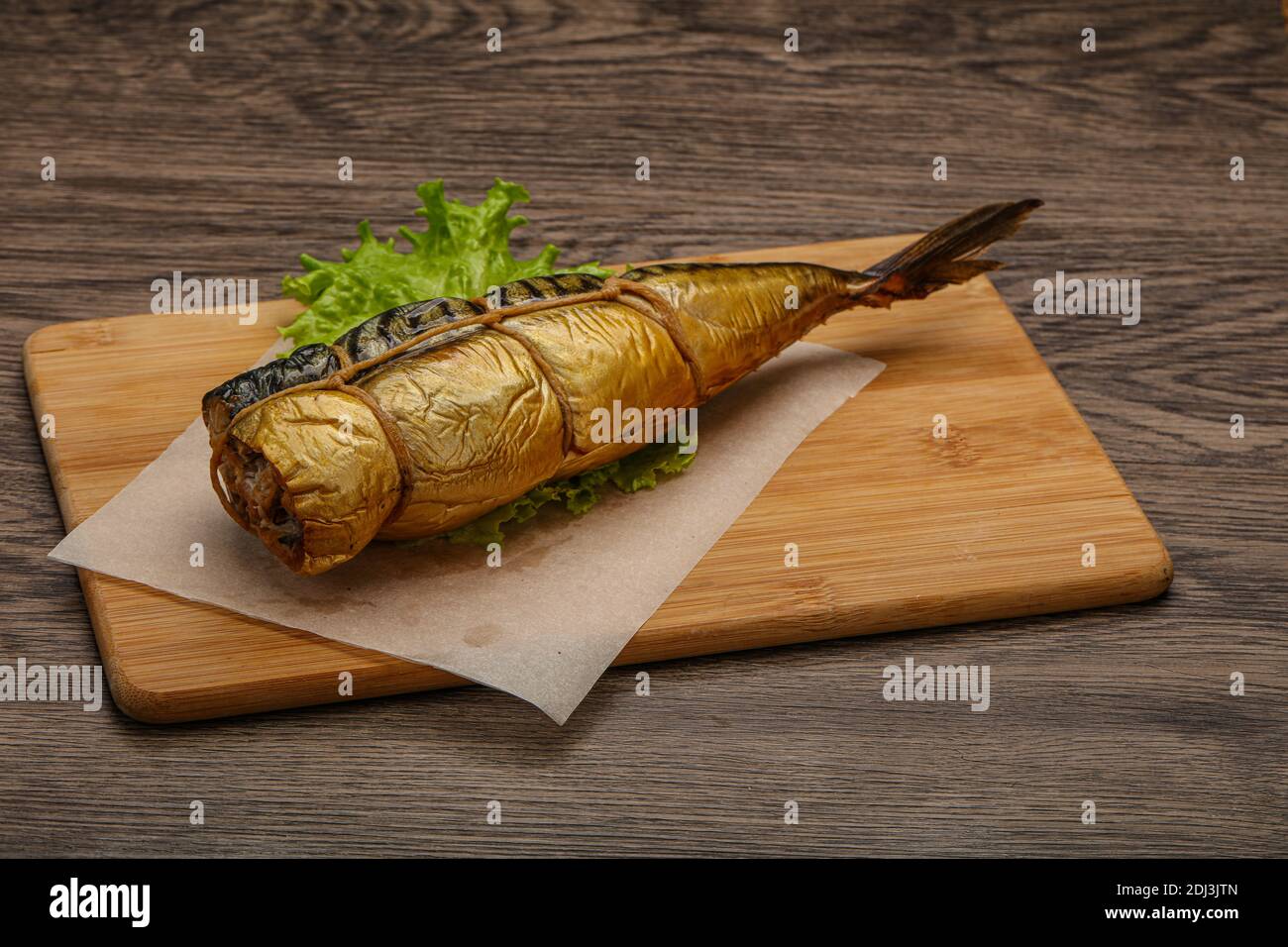 Smoked tasty mackerel fish snack over board Stock Photo - Alamy