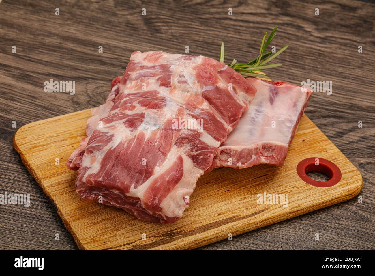 Raw pork ribs served rosemary for cooking Stock Photo - Alamy