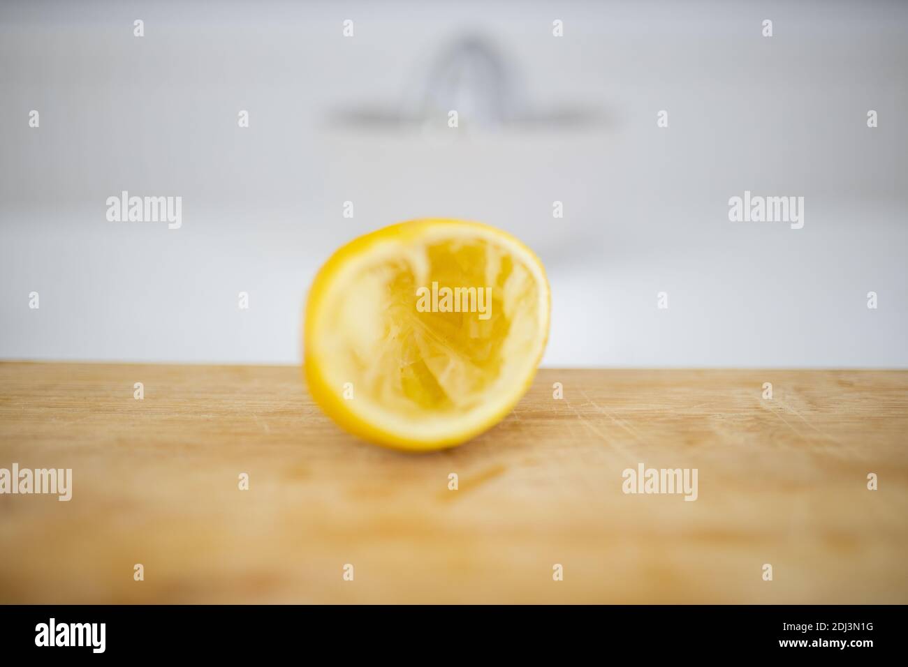 Empty lemon peel on a cutting board with white background Stock Photo ...