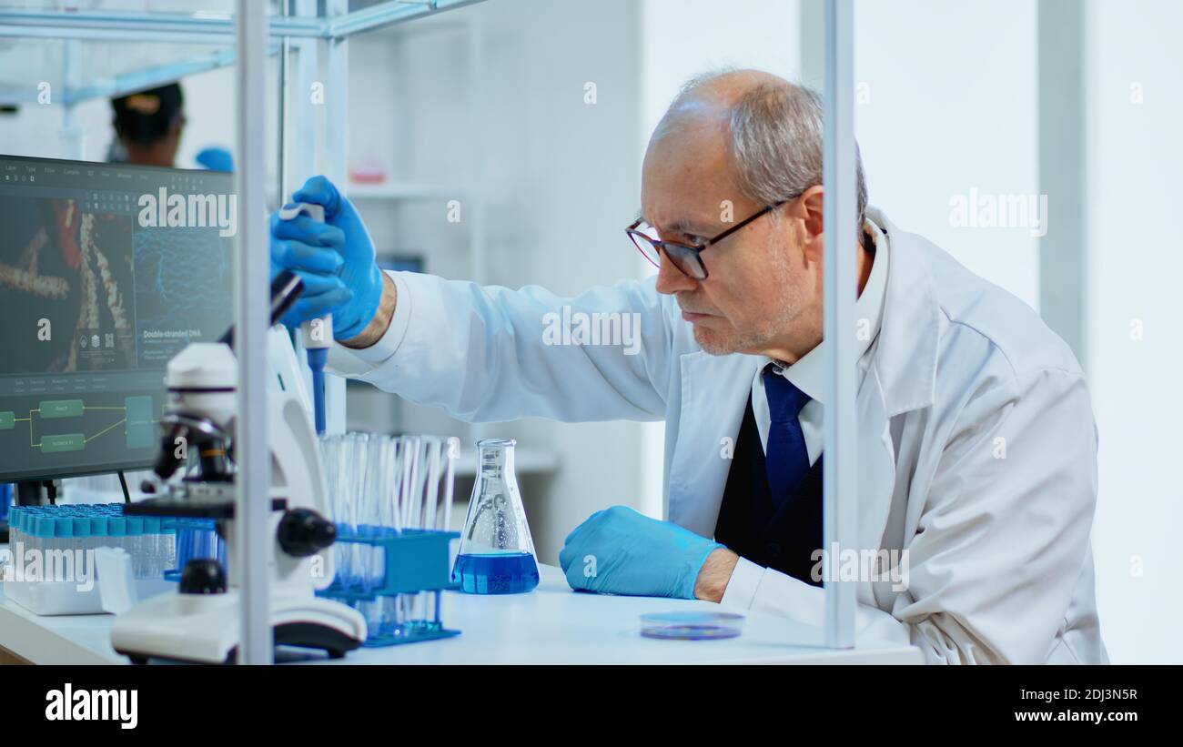 Elderly man scientist using micropipette hi-res stock photography and ...