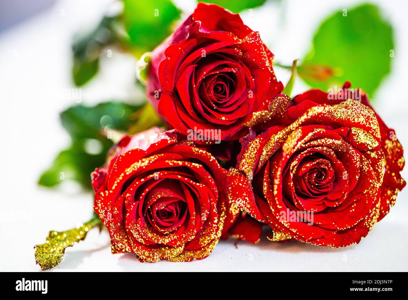 red roses with glitter in snow Stock Photo - Alamy