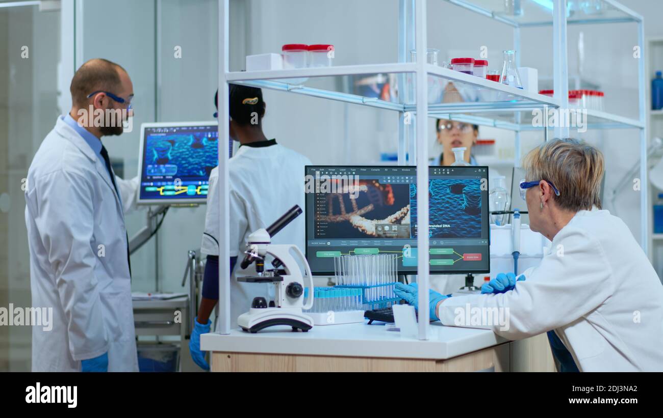 Multiethnic team working to develop a new vaccine in modern equipped ...