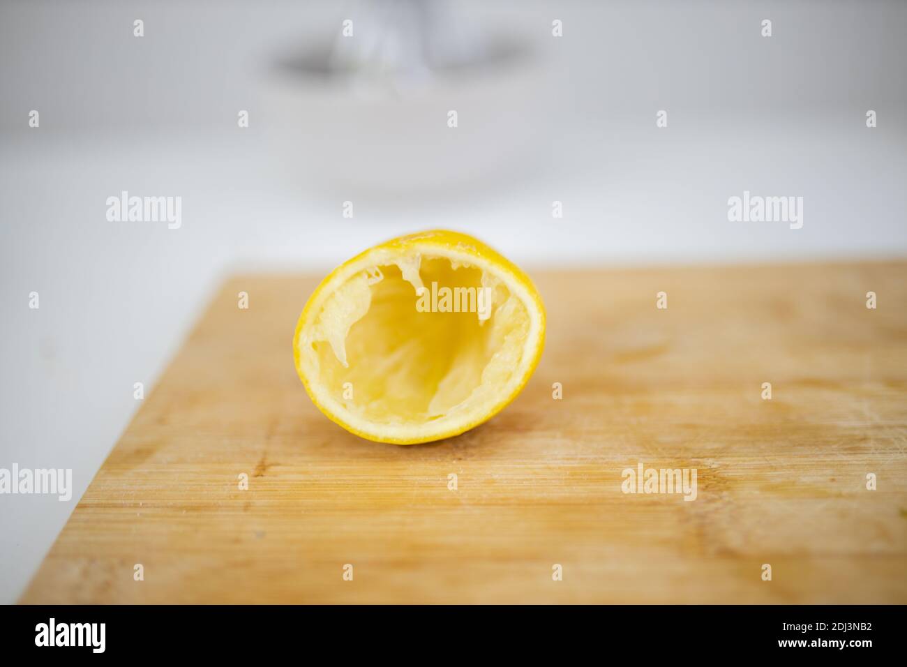 Empty lemon peel on a cutting board with white background Stock Photo ...