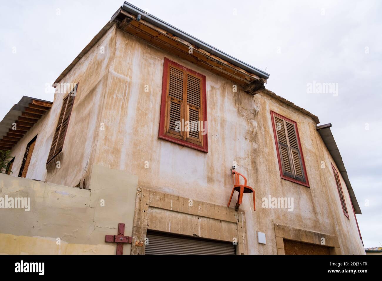 A traditional house with a prominent hanging chair and beautiful wooden ...