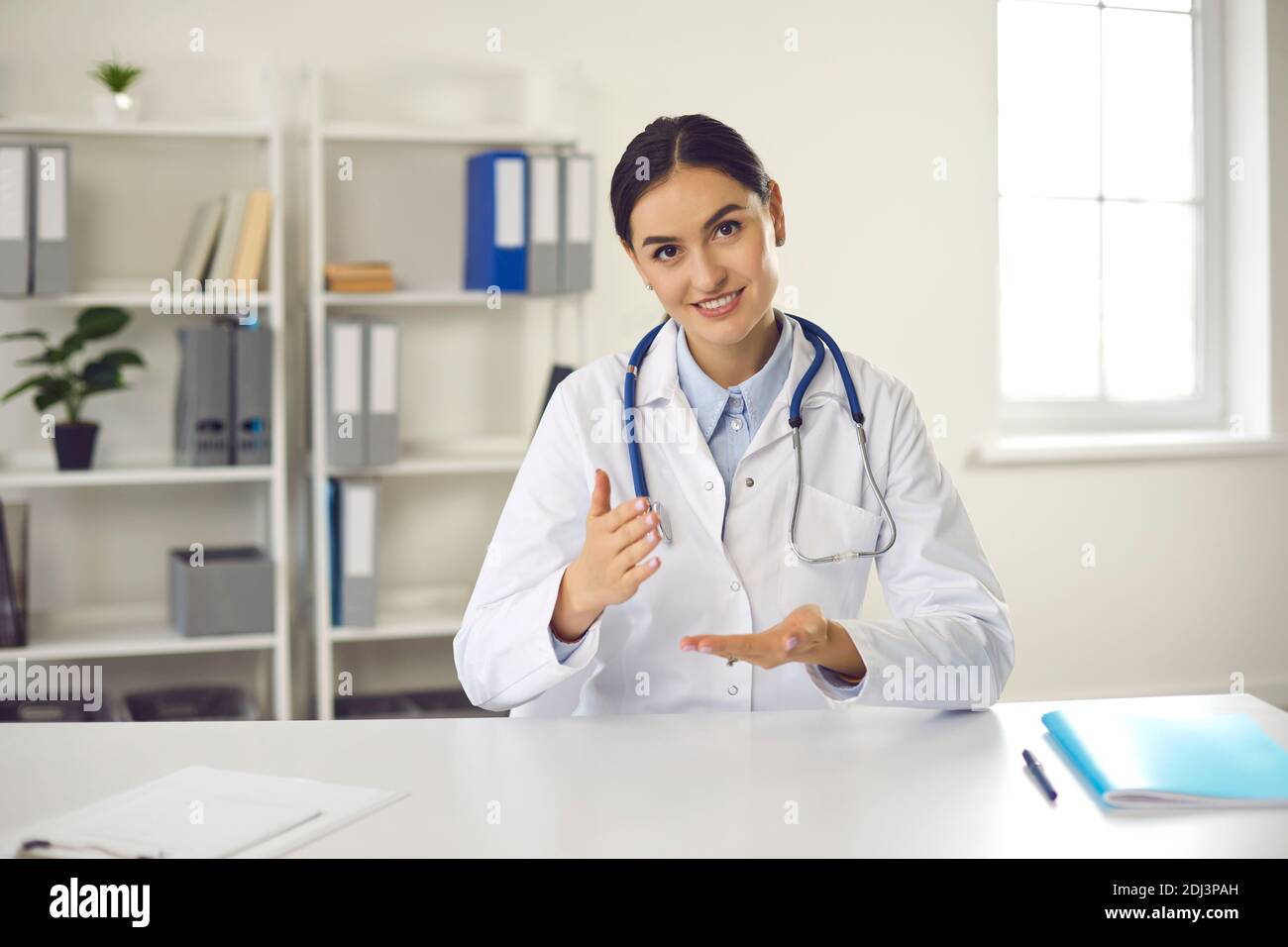 Female family doctor conducts an online consultation with his patient ...