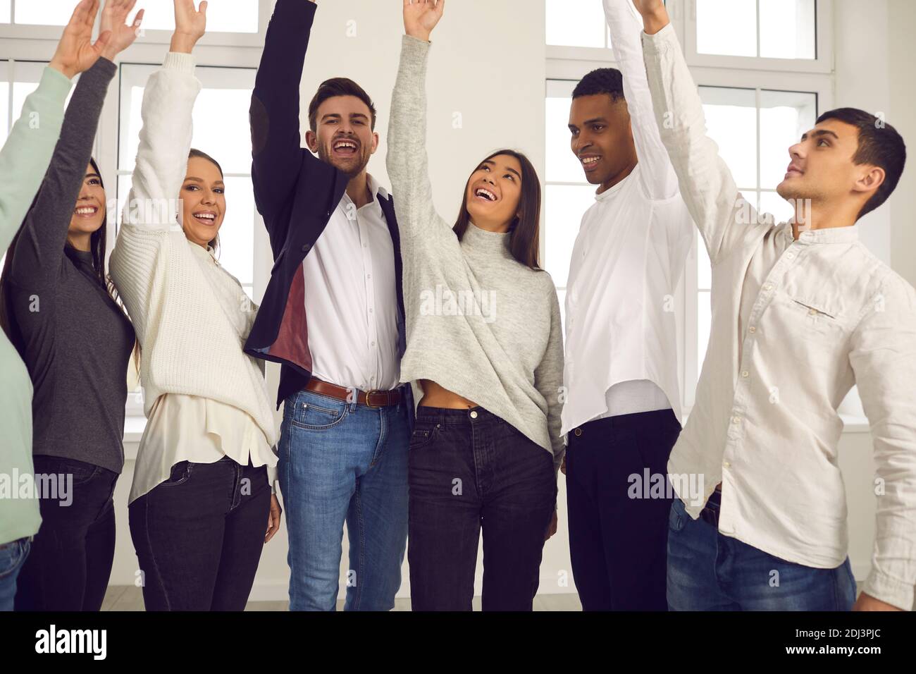 Happy young multiracial business team cheering and celebrating ... Happy young multiracial business team cheering and celebrating ...