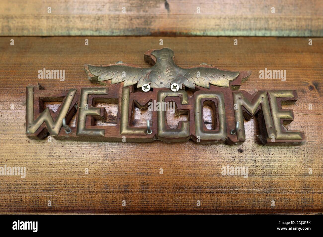 Sign welcome bolted on a wooden wall Stock Photo - Alamy