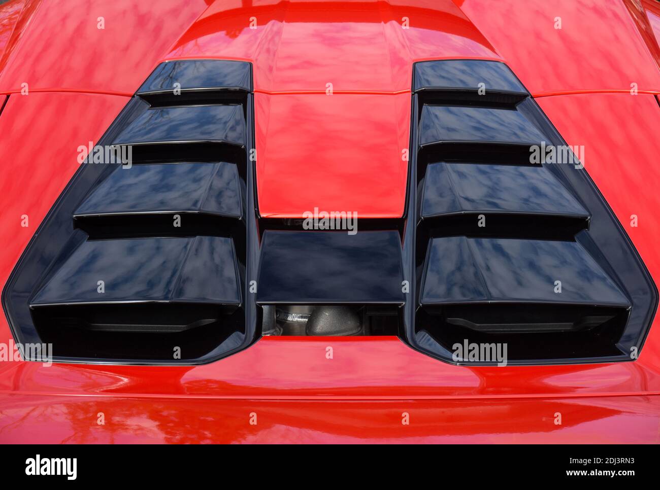 Close up detail of the rear slatted engine cover on a Rosso Mars red ...