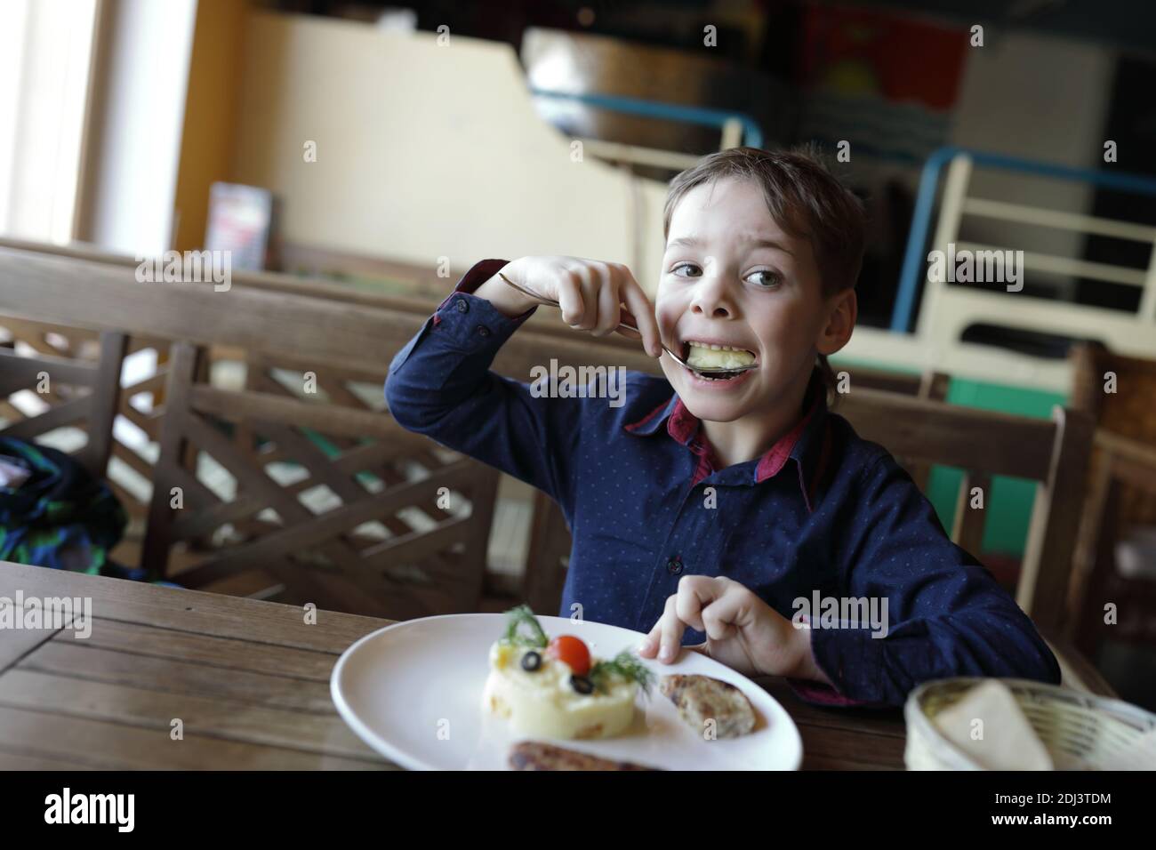 Boy eating mashed potatoes in a cafe Stock Photo - Alamy