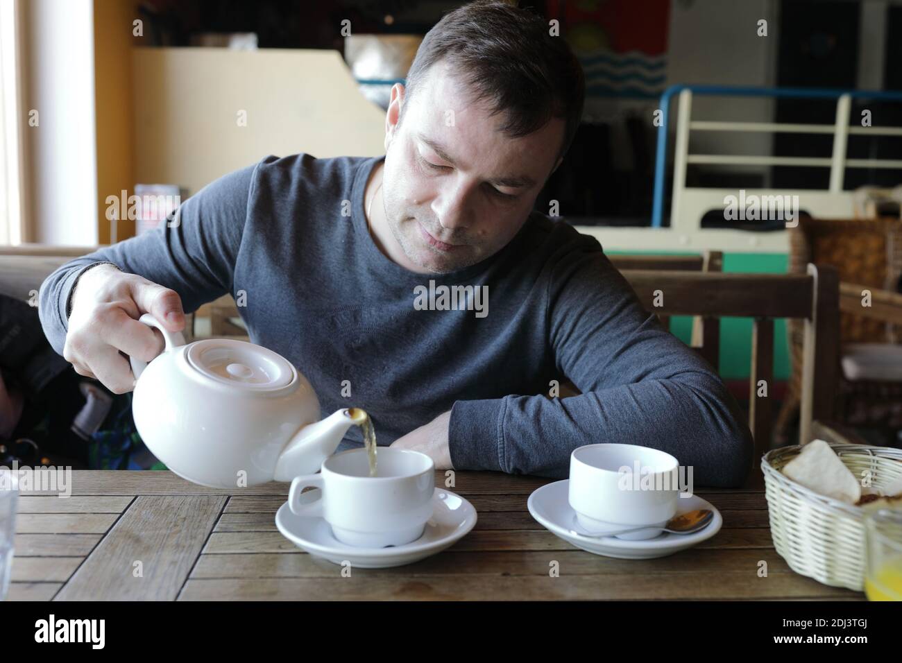 Man pouring green tea in a restaurant Stock Photo - Alamy
