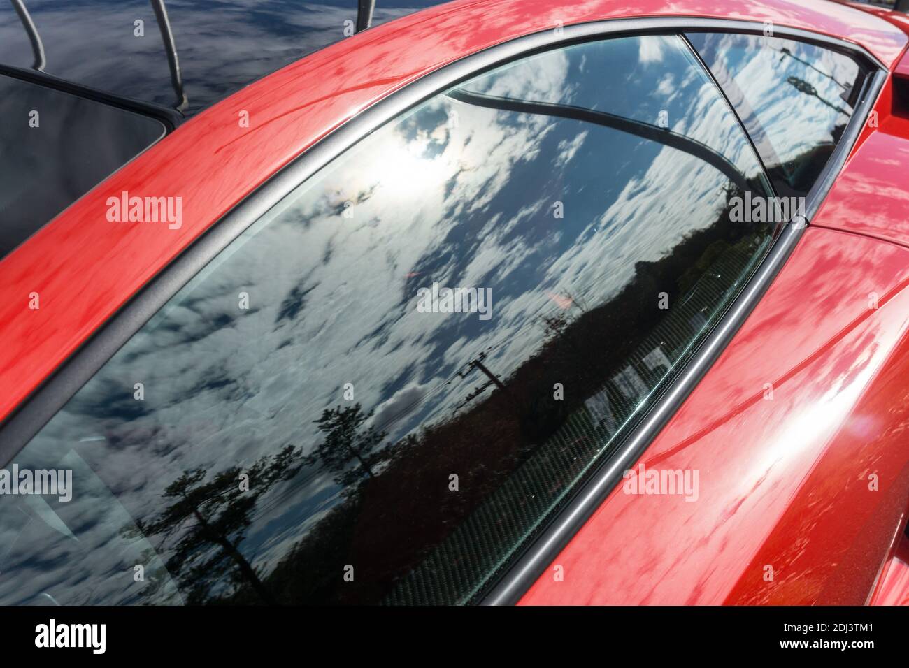 Close up detail of the left side windows and door of a Rosso Mars red ...