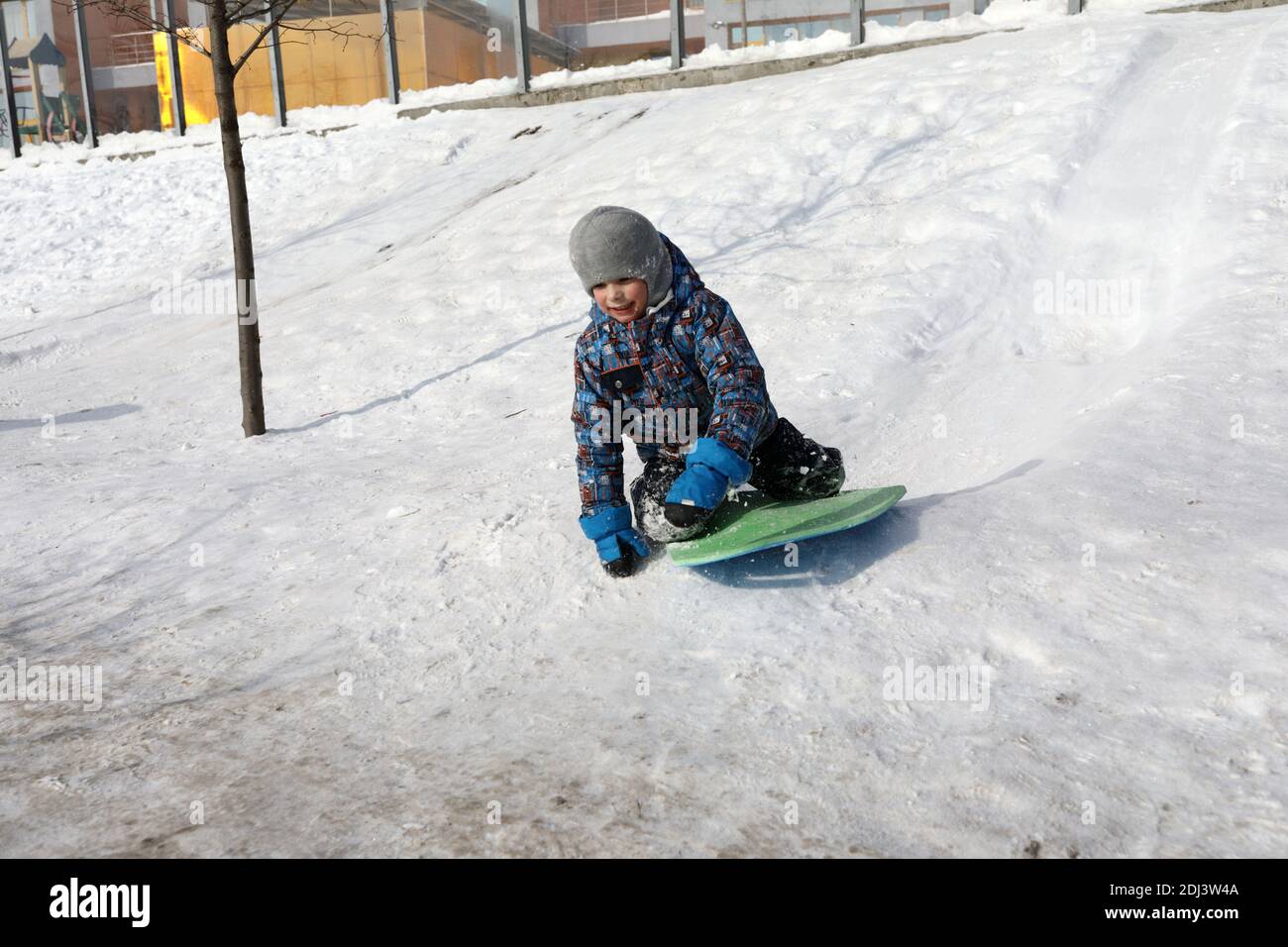 Preschooler sled ride on snow hill in winter Stock Photo - Alamy