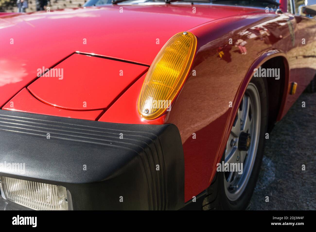 Close up detail of the front indicator, bonnet and bumper on a red ...
