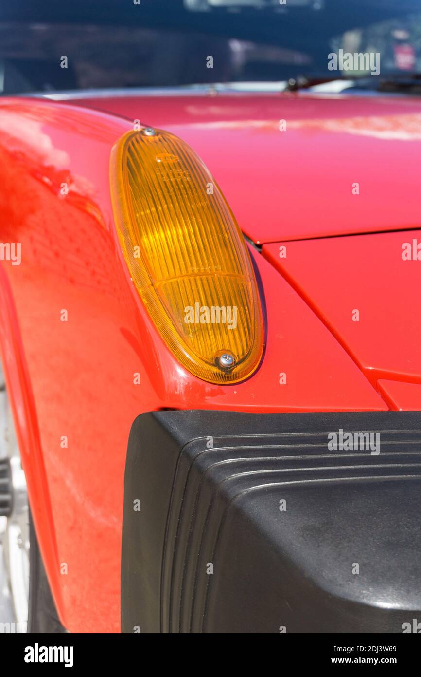 Close up detail of the front indicator, bonnet and bumper on a red ...