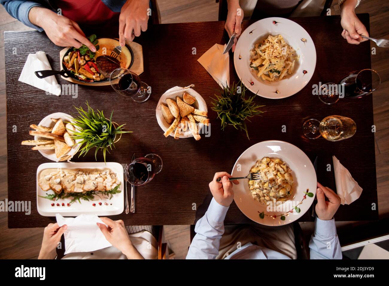 Group of young people having dinner in the restaurant Stock Photo - Alamy