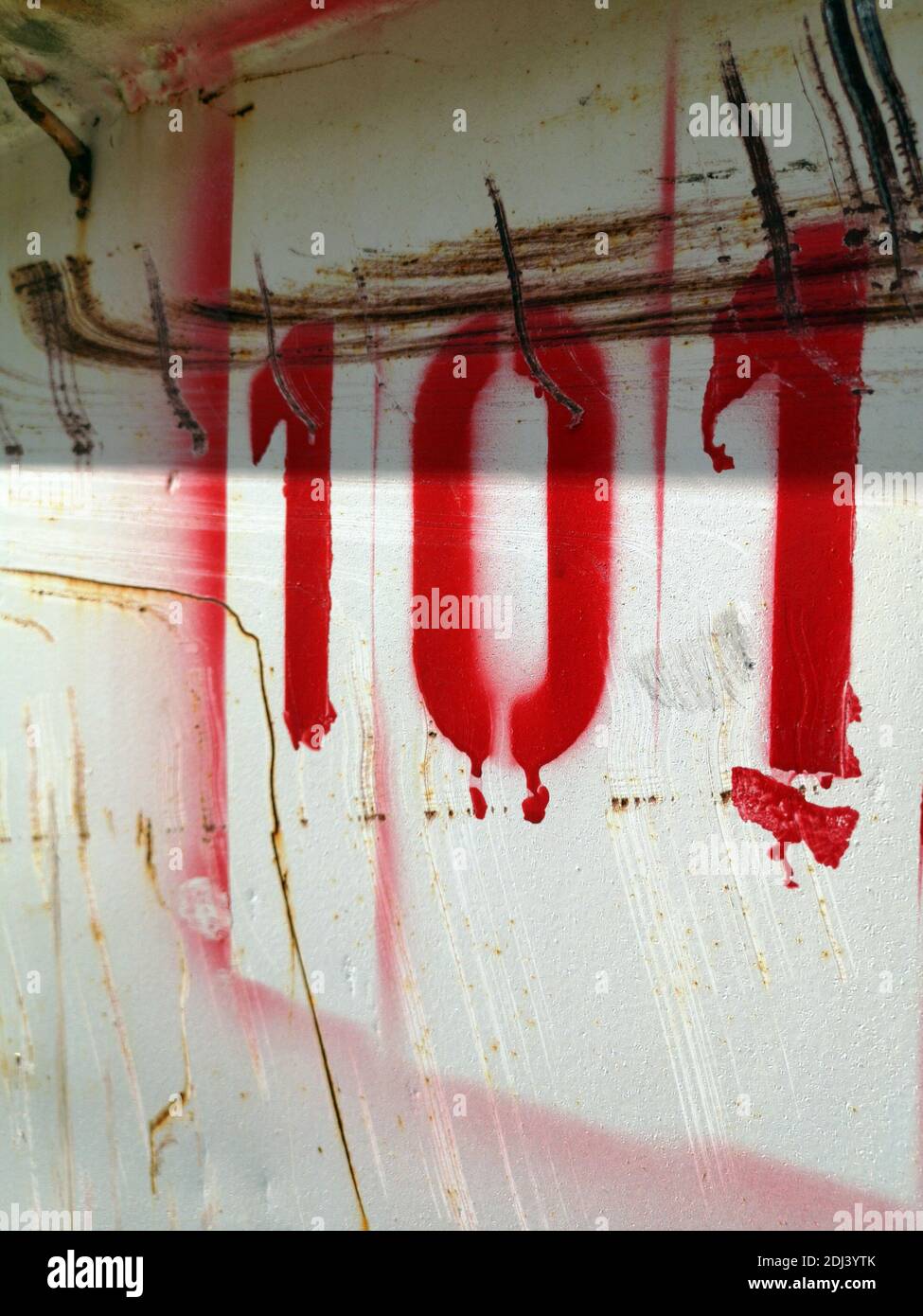 A vertical shot of the number 101 in red paint on a rusty wall Stock ...
