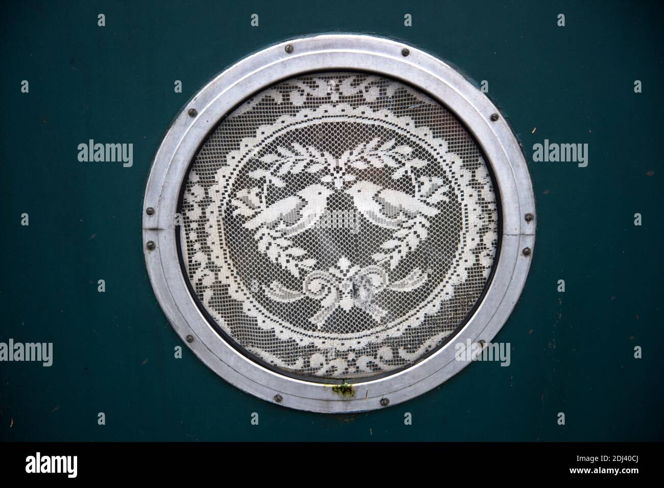 London, Tower Hamlets. Regents Canal. Porthole window of canal boat ...