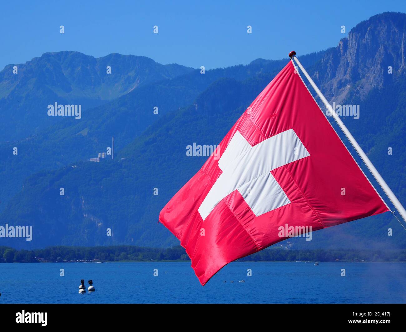 Red and white Swiss national flag at Leman Lake in Switzerland Stock ...
