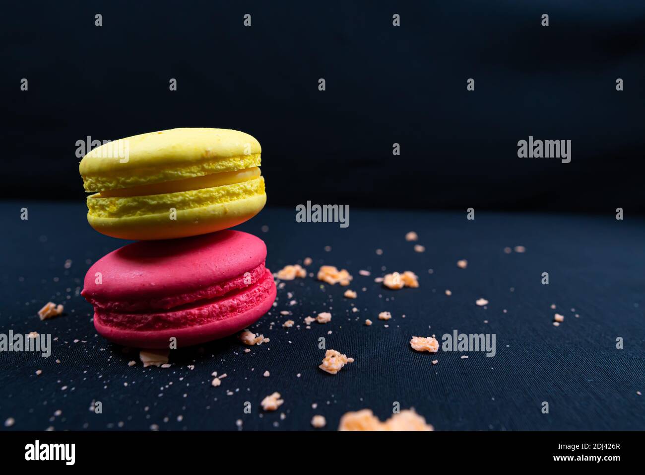 Colourful stack of macaroons isolated on plain black background ...
