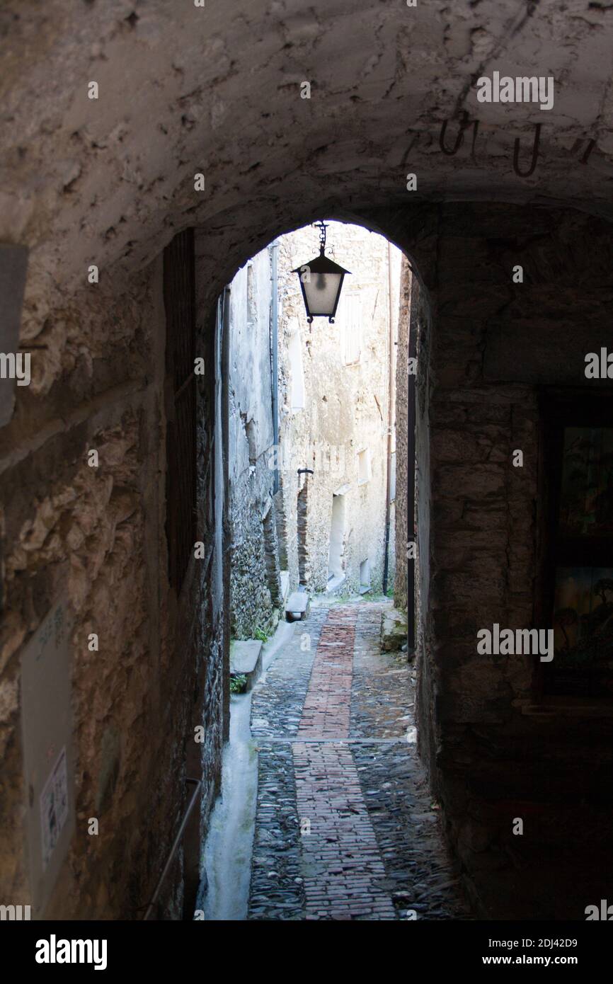 Colorful narrow alley in a traditional Italian village Stock Photo - Alamy