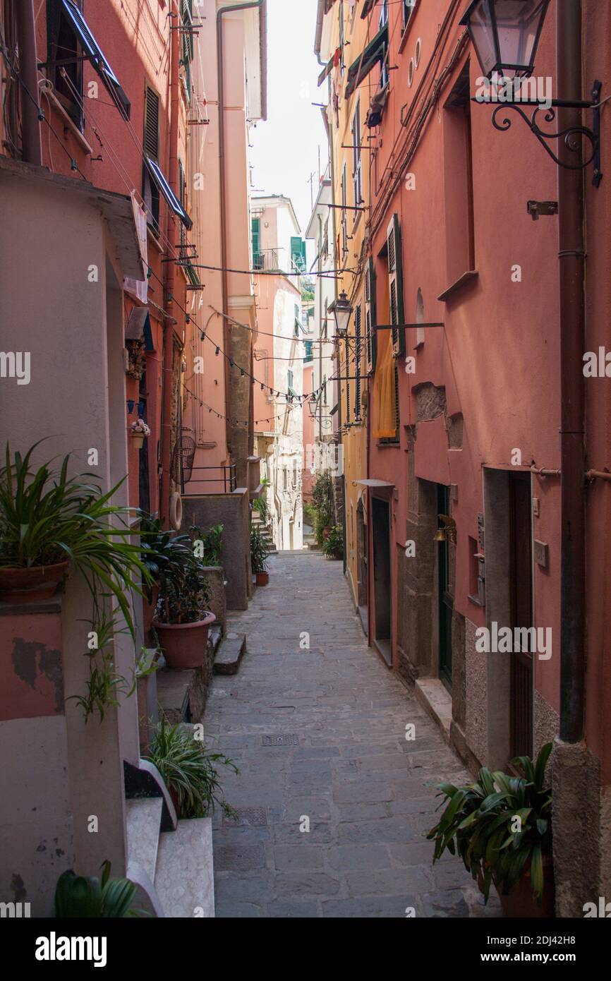 Colorful narrow alley in a traditional Italian village Stock Photo - Alamy