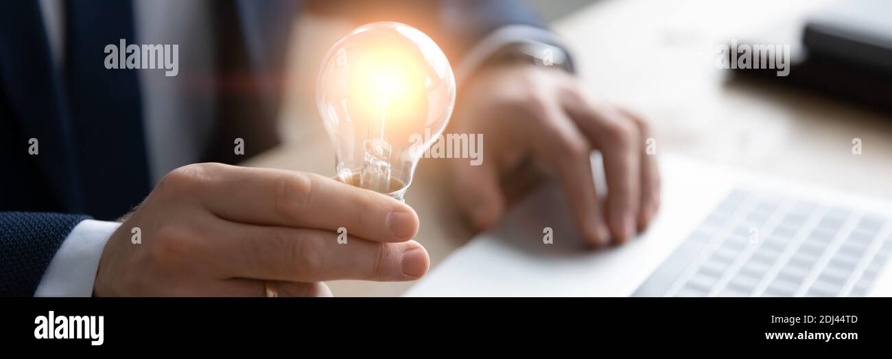 Horizontal banner close up businessman holding light bulb, inspiration ...
