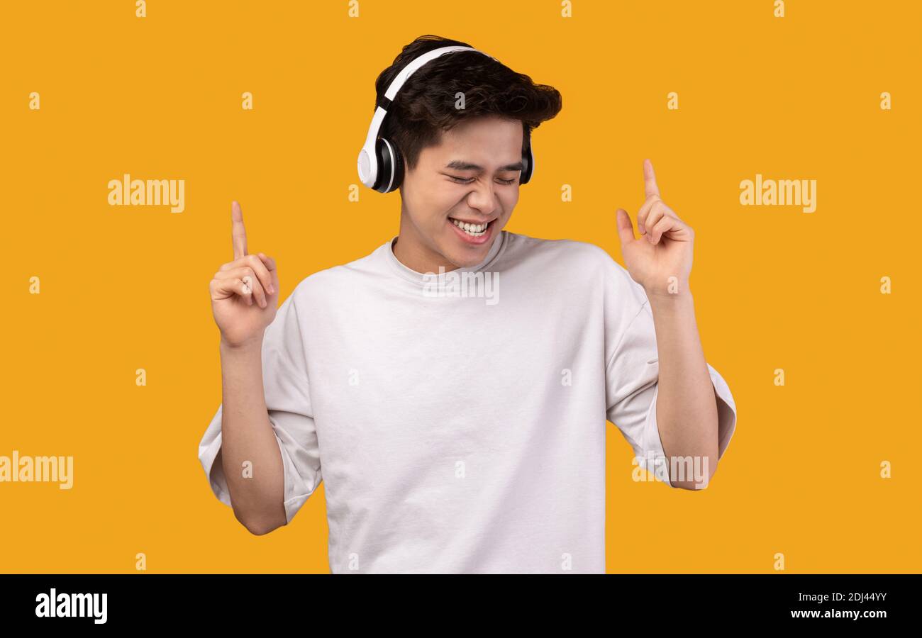 Happy asian man enjoying music hi-res stock photography and images - Alamy